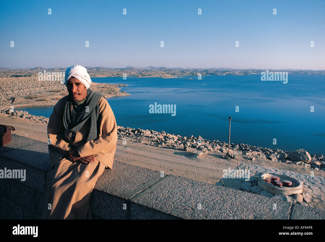 A muslim Egyptian arab sitting on the parapet of the Asan High Dam ...