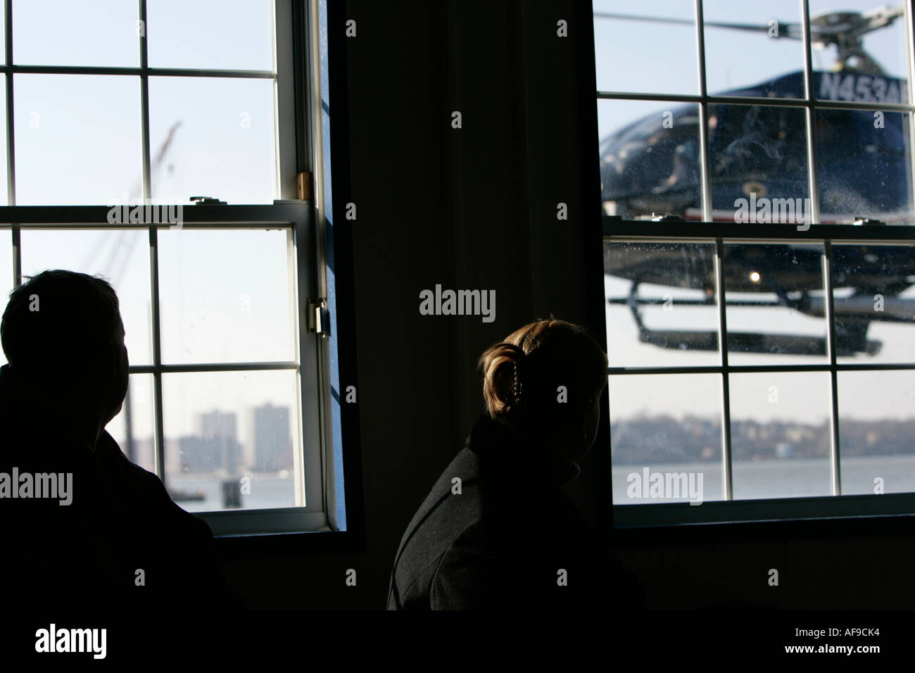 EC130 american eurocopter comes in to land watched by two passengers ...