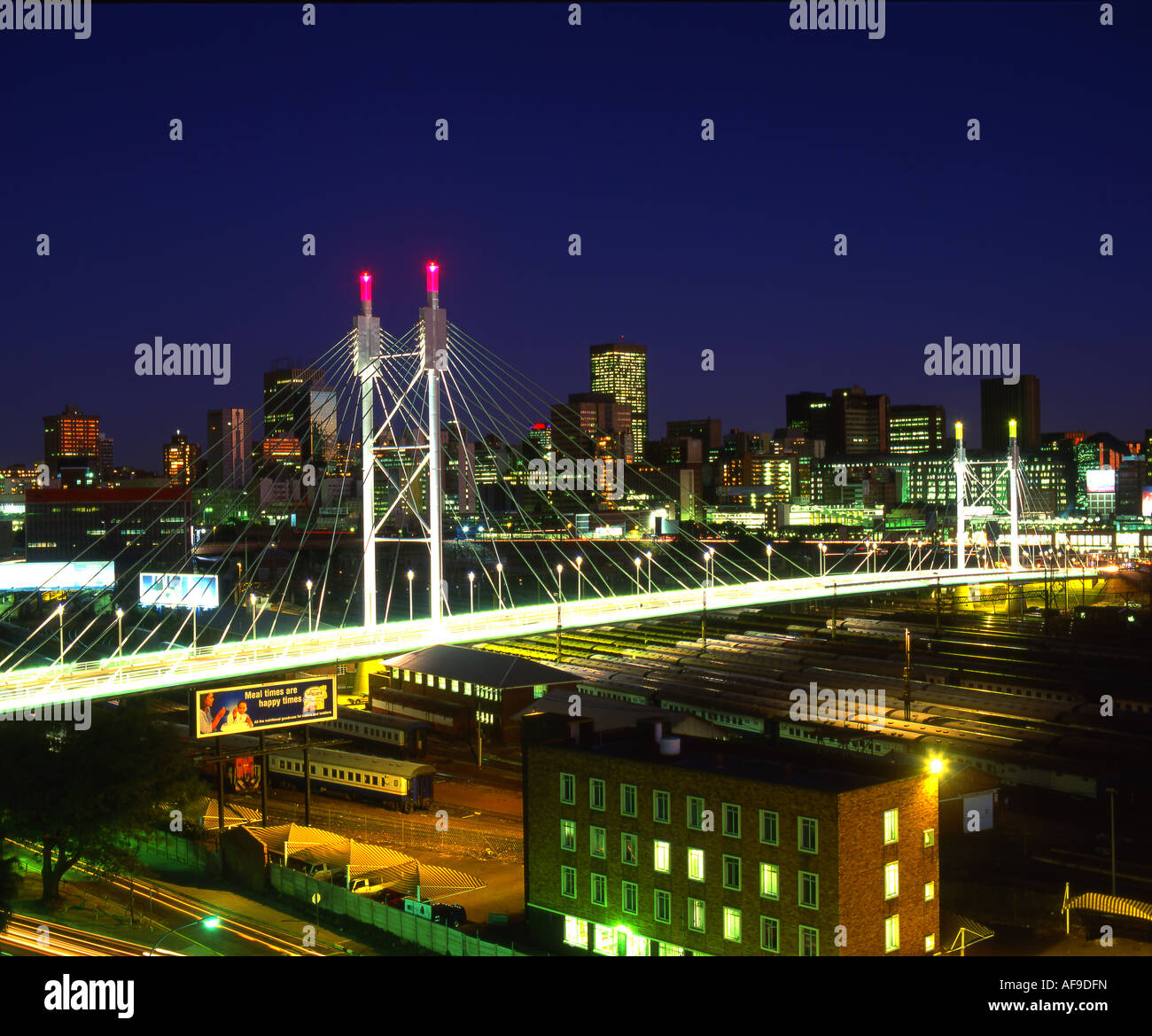 Nelson Mandela Bridge at night where it crosses over the railway tracks ...