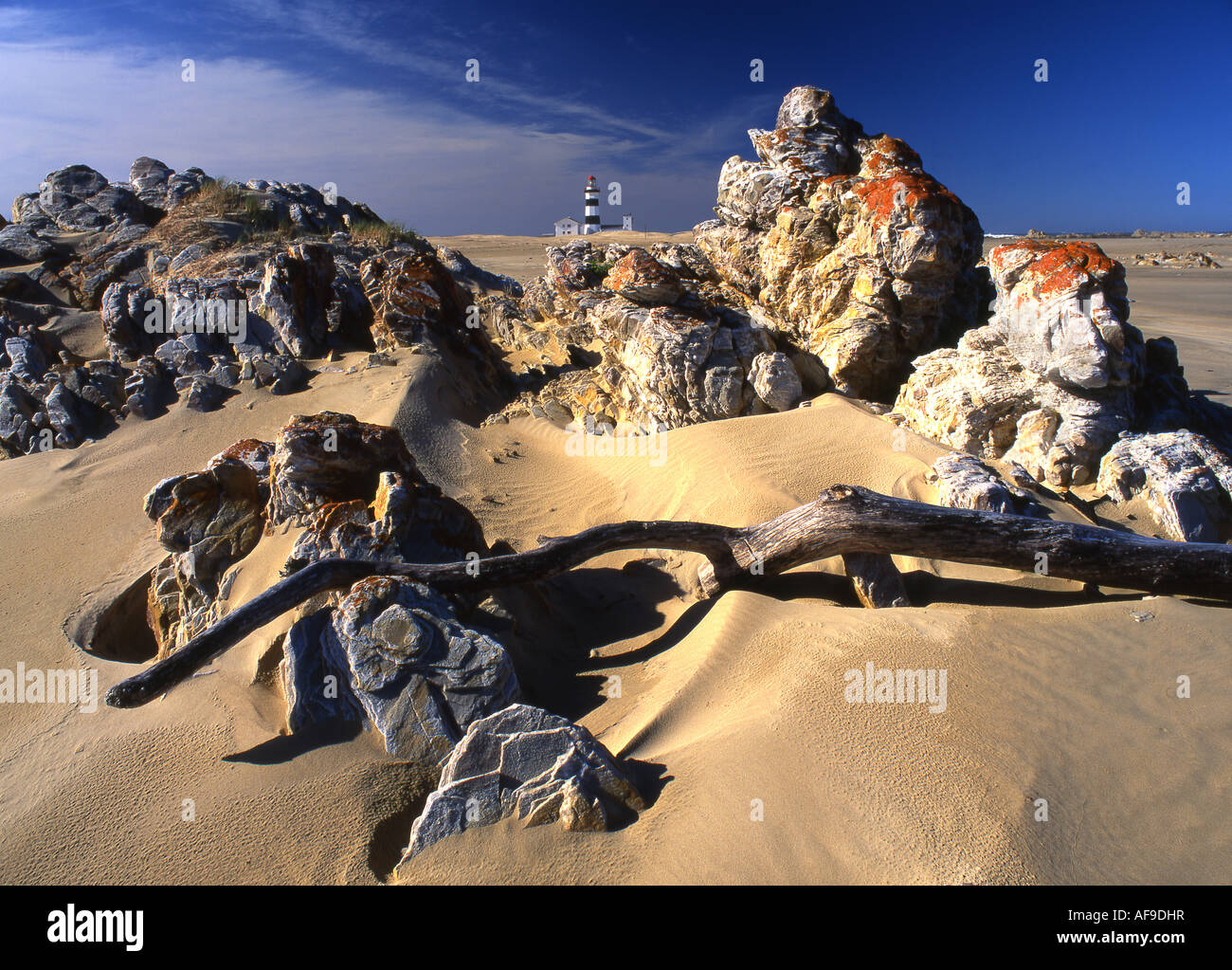 Wind-blown beach sand blown up against rocks in the Cape Recife Nature ...