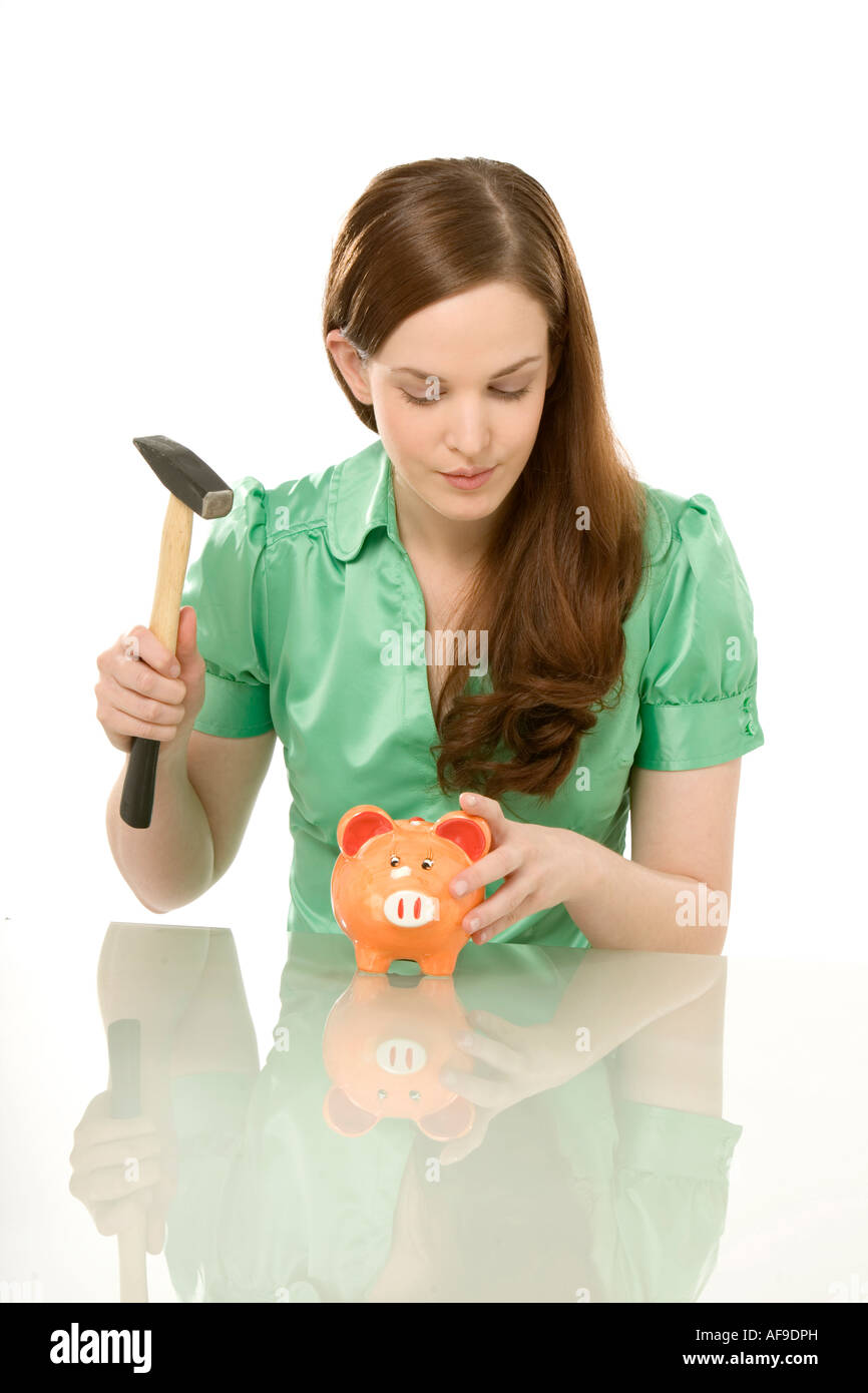 Young woman breaking piggy bank, portrait Stock Photo - Alamy