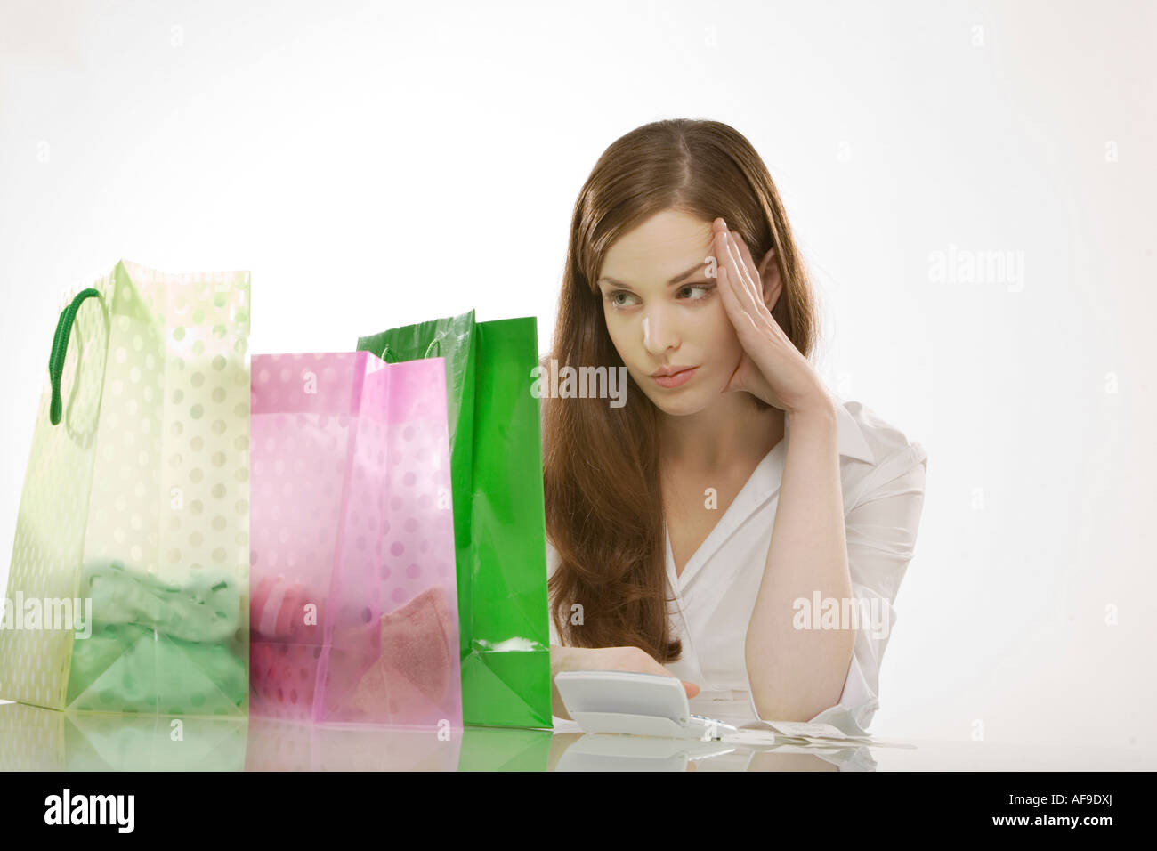 Young womanwith shopping bags, thinking, portrait Stock Photo - Alamy