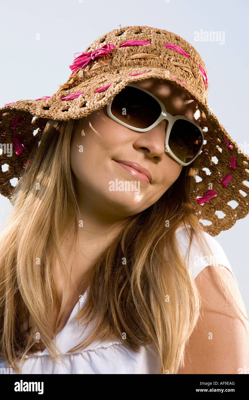 Young woman wearing straw hat, portrait Stock Photo - Alamy