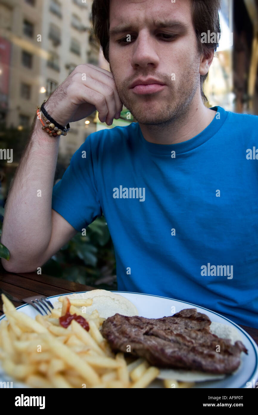 Man Looking Down at his Plate of Food Stock Photo - Alamy