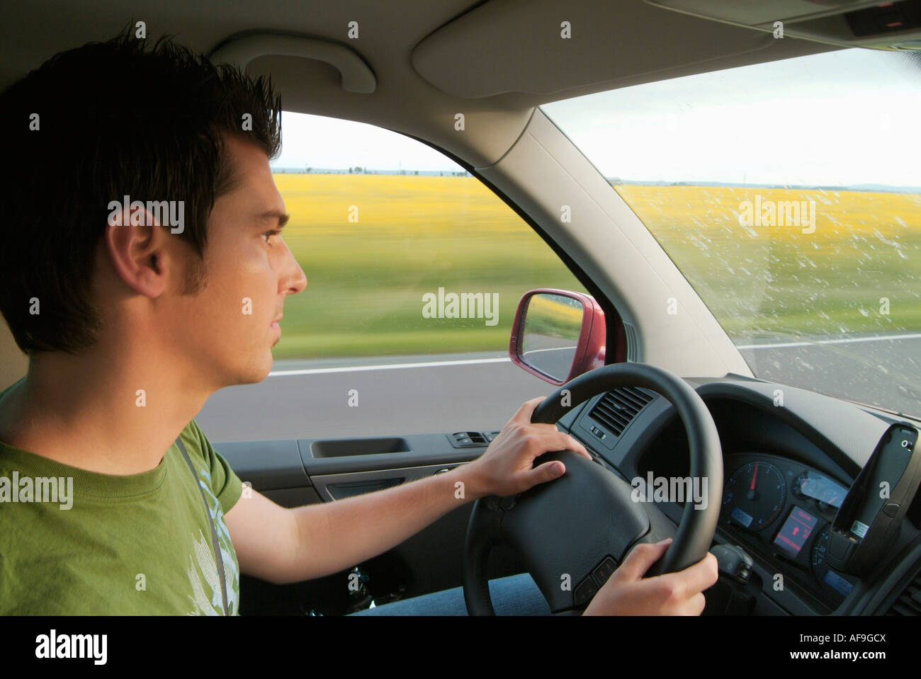 Man driving car, side view Stock Photo - Alamy