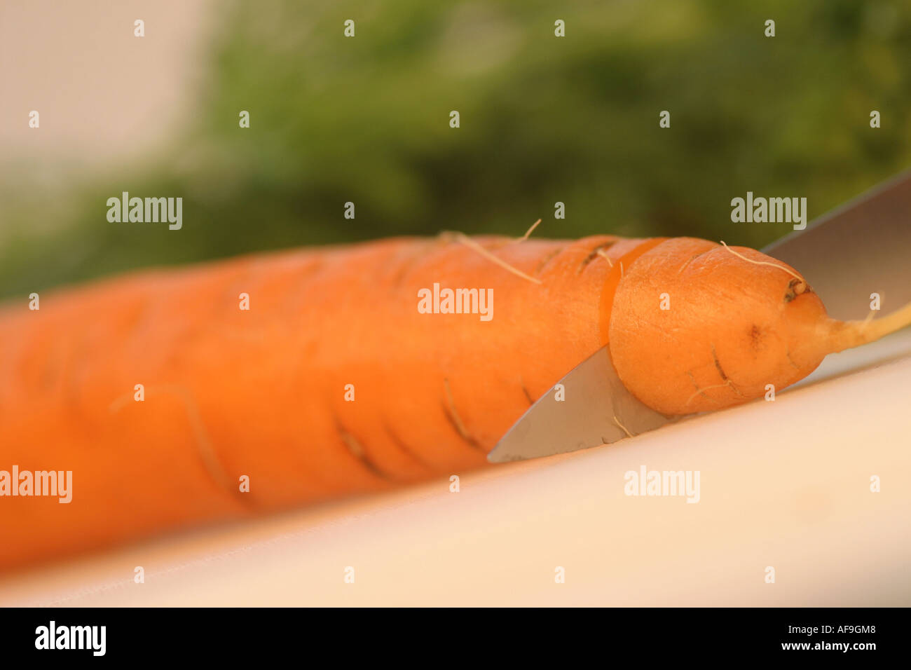 A Stock Photograph of a Carrot Getting Cut Up With a Knife Stock Photo ...