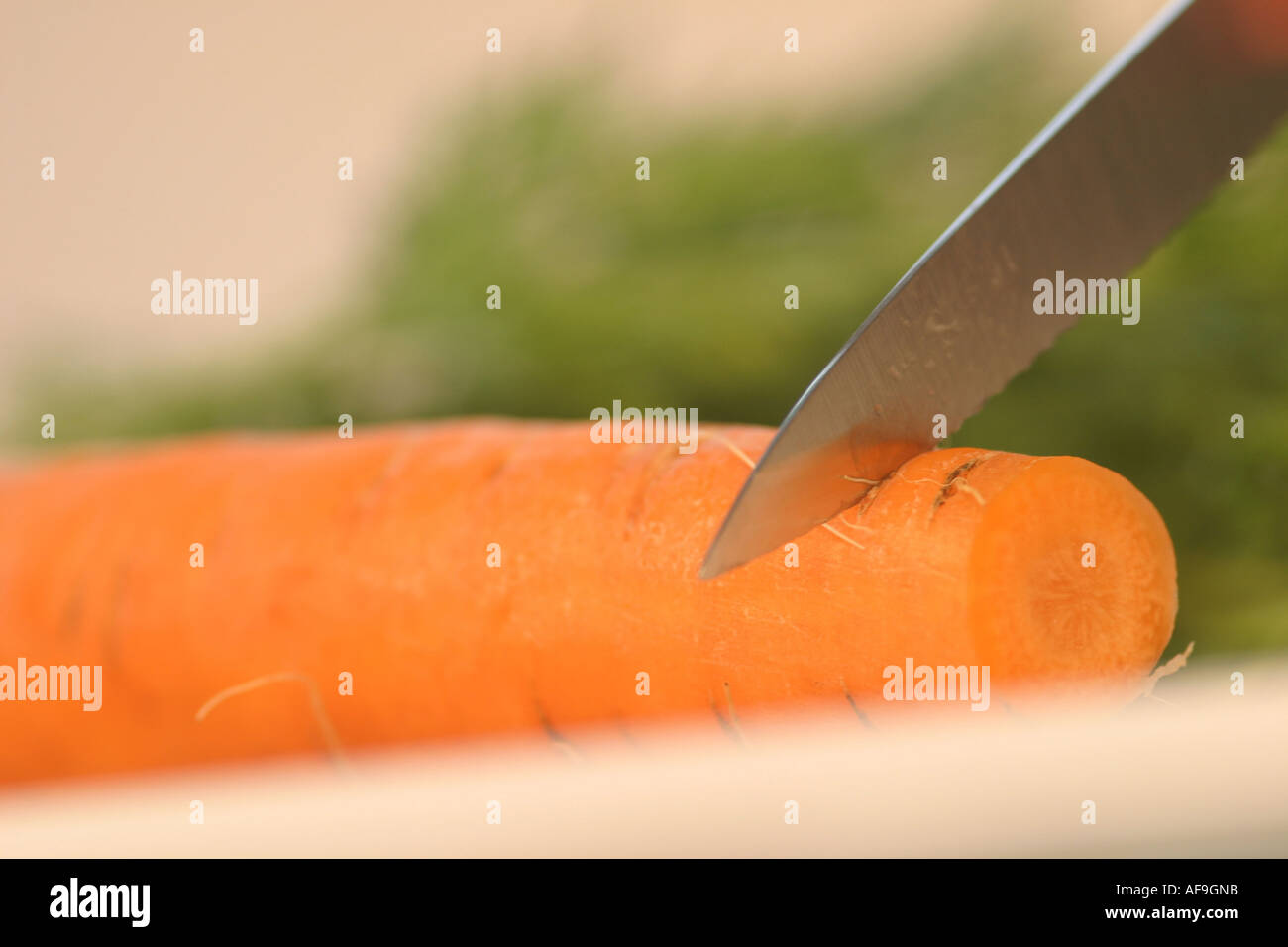A Stock Photograph of a Carrot Getting Cut Up With a Knife Stock Photo ...