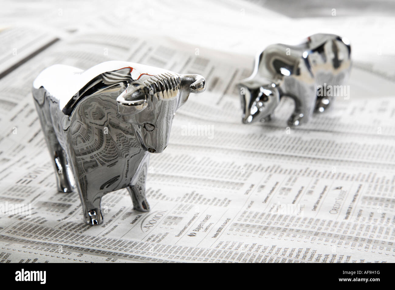 Bull and baer figurines on journal, close-up Stock Photo - Alamy