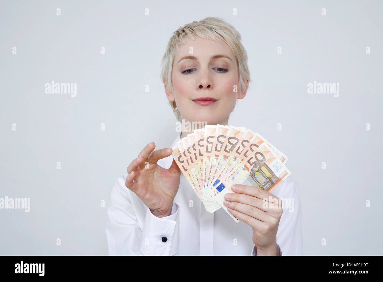 Young woman holding money, portrait Stock Photo - Alamy