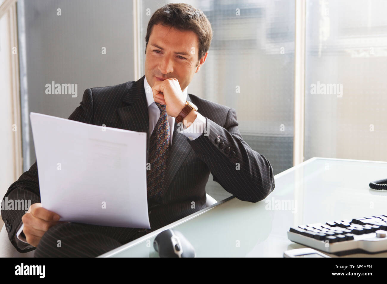 Business man reading papers, portrait Stock Photo - Alamy