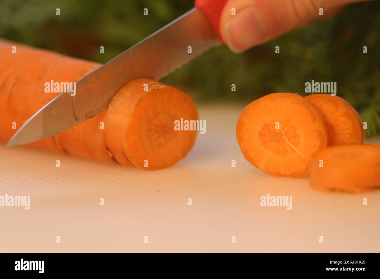 A Stock Photograph of a Carrot Getting Cut Up With a Knife Stock Photo ...