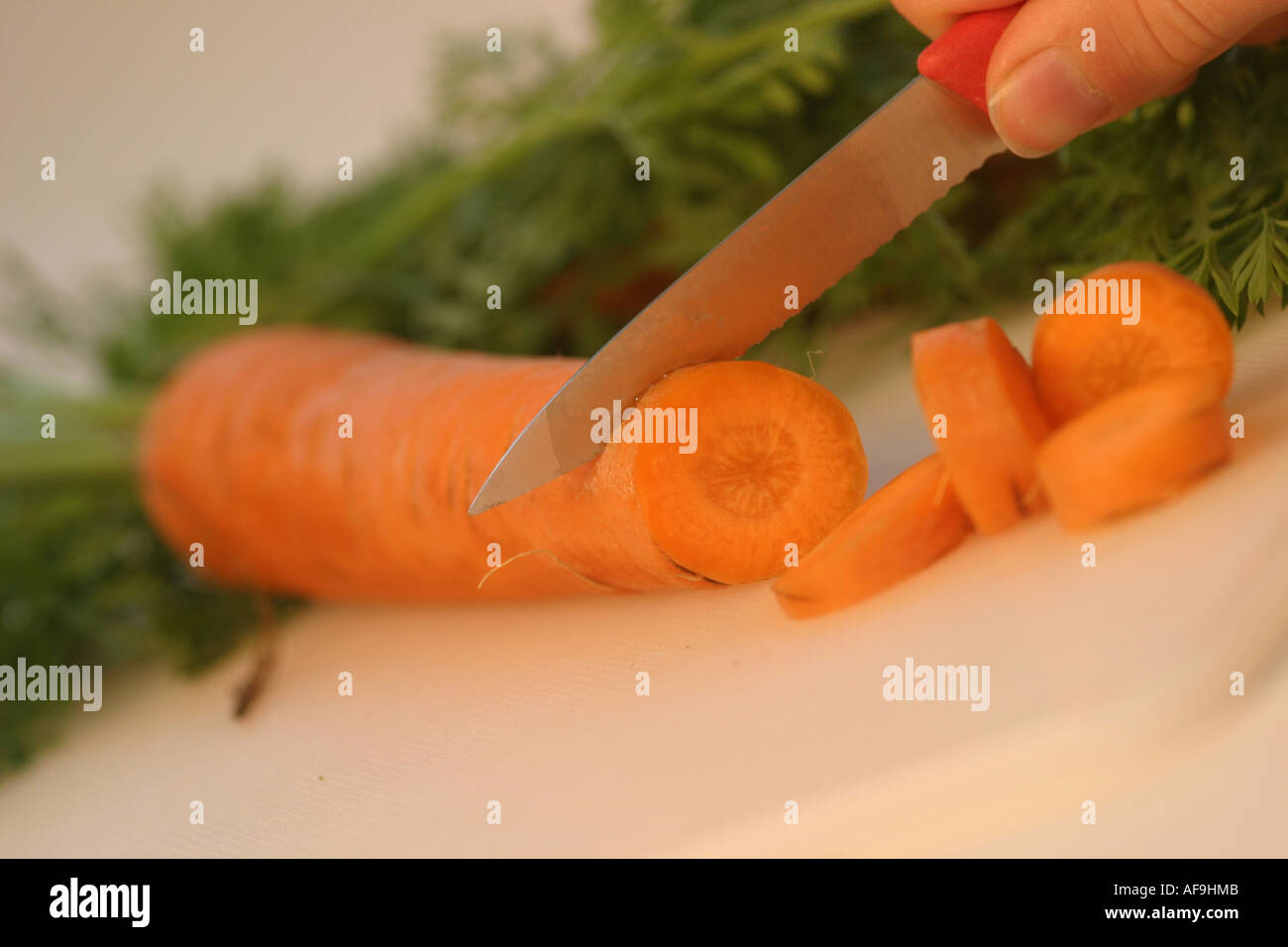 A Stock Photograph of a Carrot Getting Cut Up With a Knife Stock Photo ...