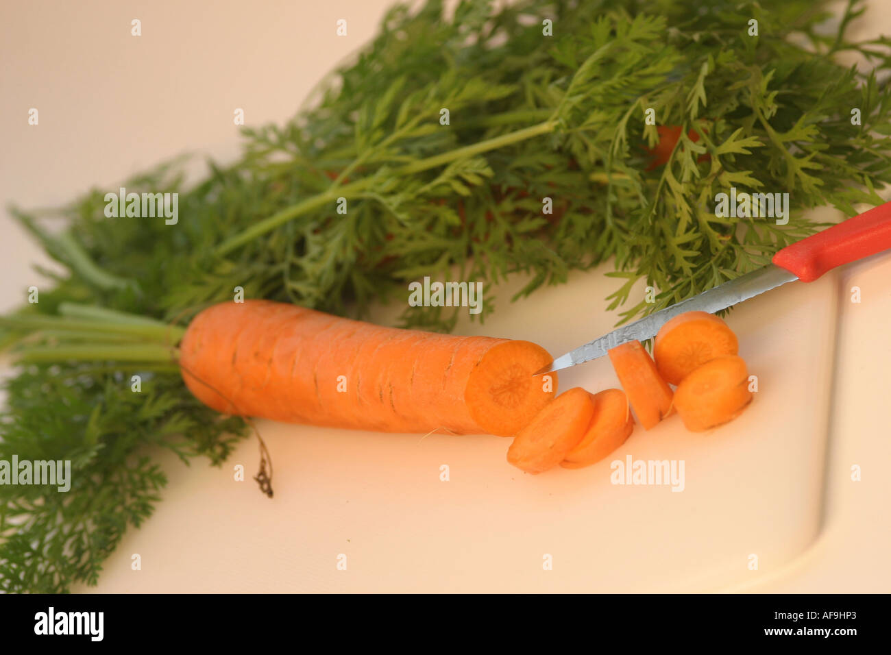 A Stock Photograph of a Carrot Getting Cut Up With a Knife Stock Photo ...