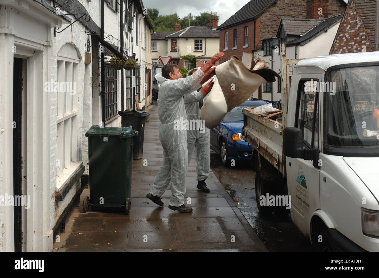 Clearing out flood damaged house in Ludlow by flooding of the river ...