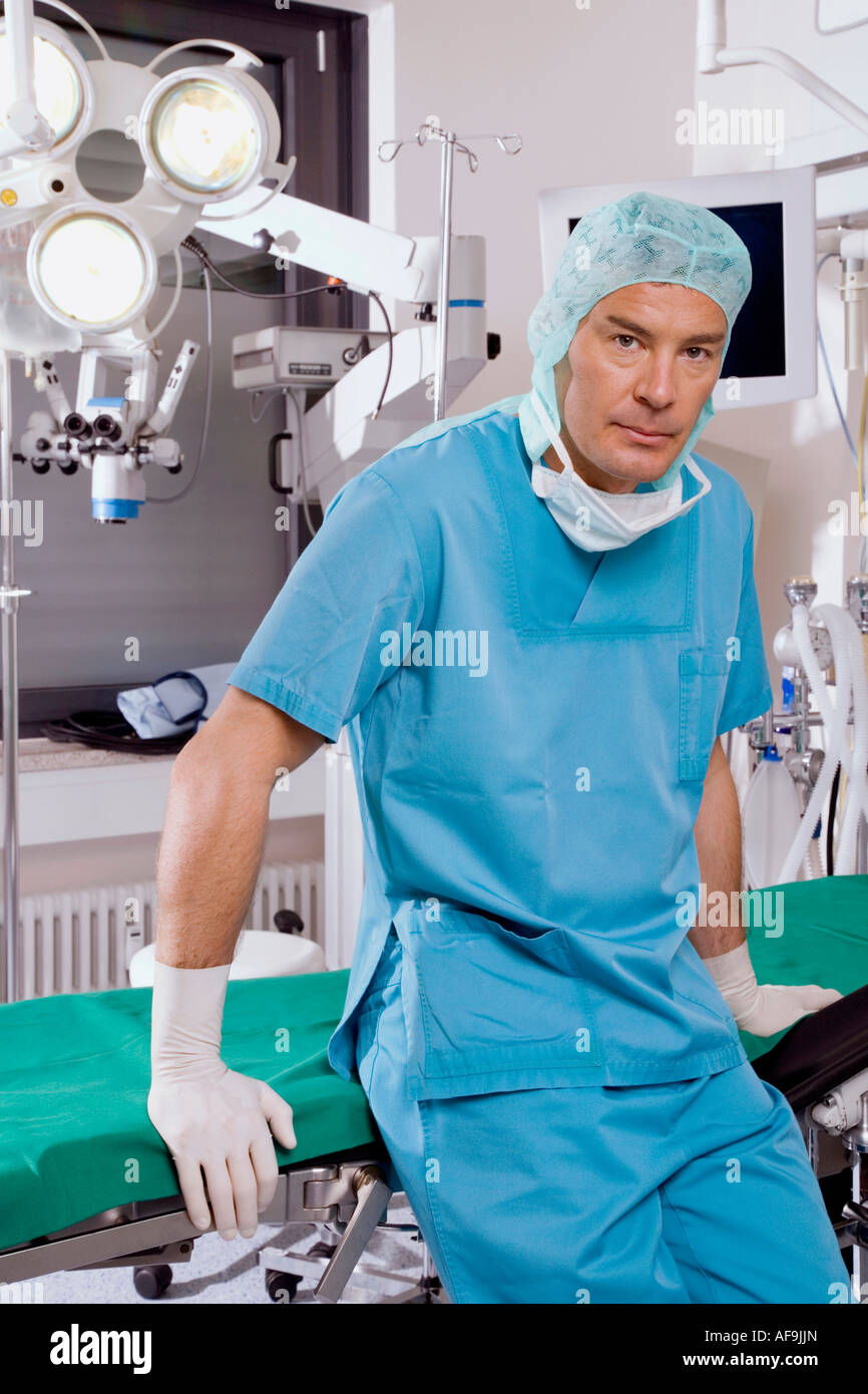 Surgeon sitting on operating table Stock Photo - Alamy