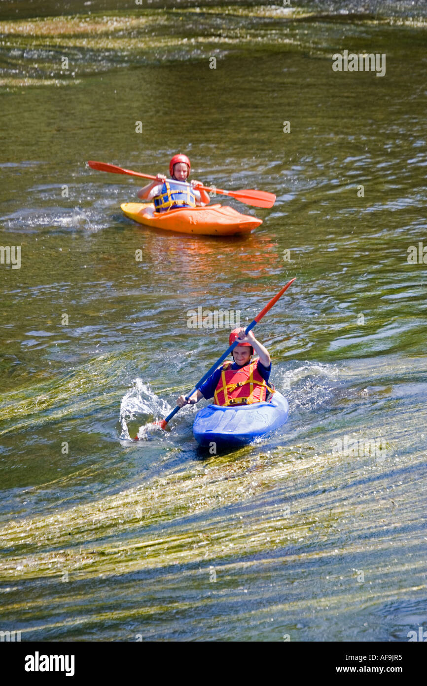 Teenage boys paddling canoes down River Wye Lower Lydbrook UK Stock ...