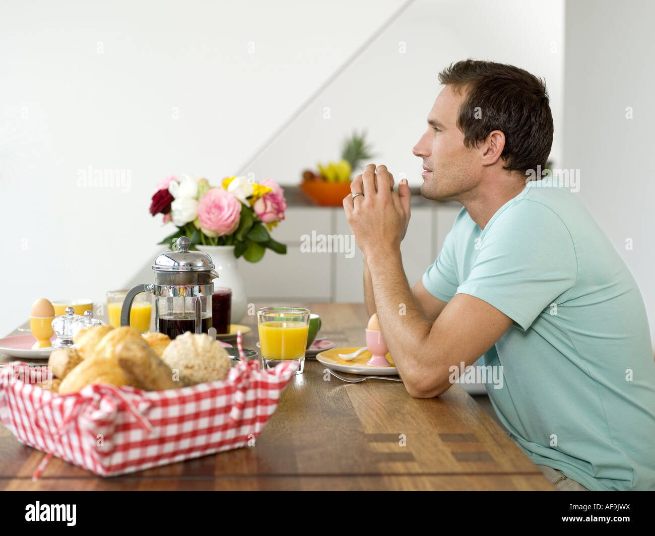 Man sitting at breakfast table Stock Photo - Alamy