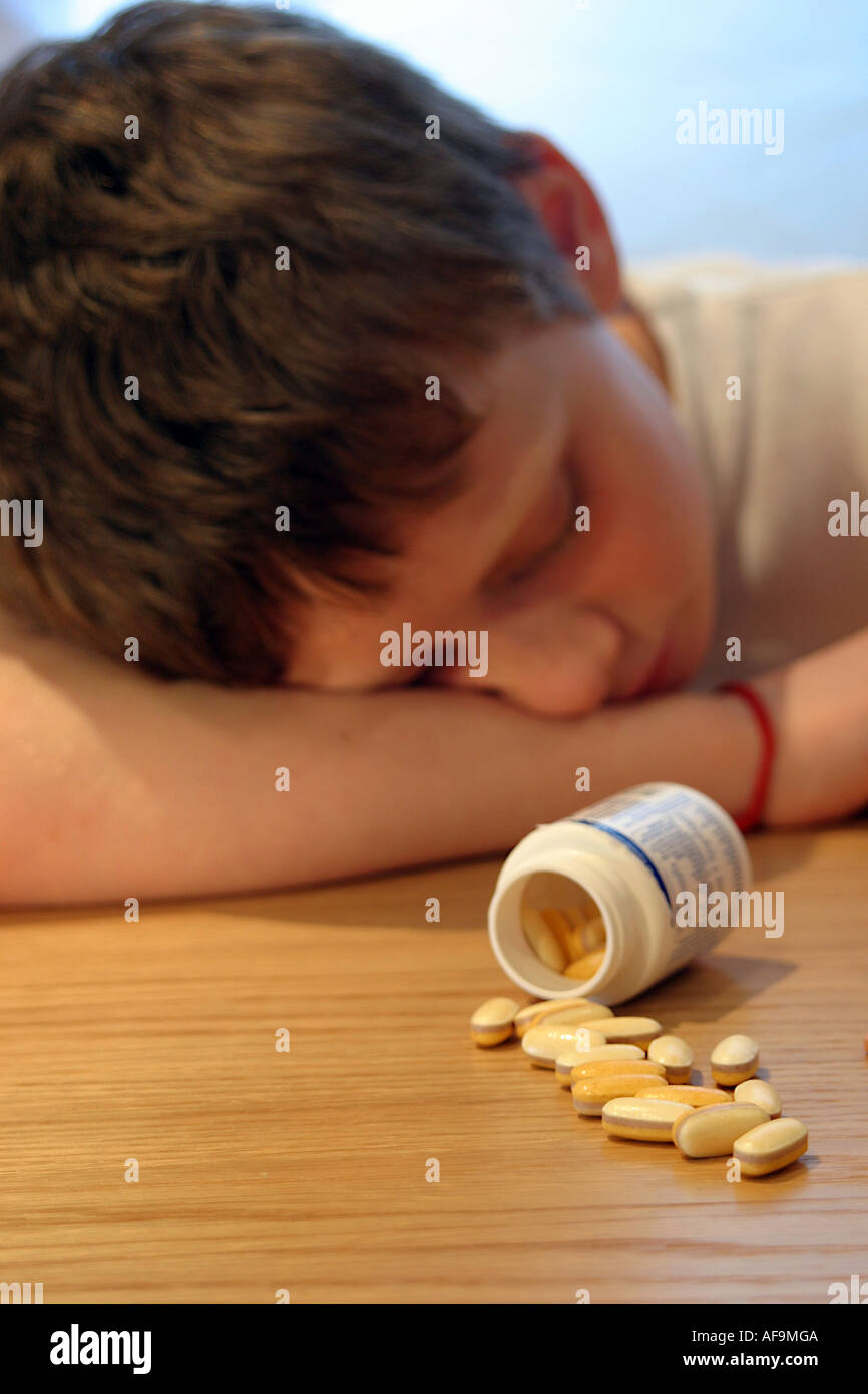 A Stock Photograph of a Yound Boy Depressed and Drugs Pouring out of a ...