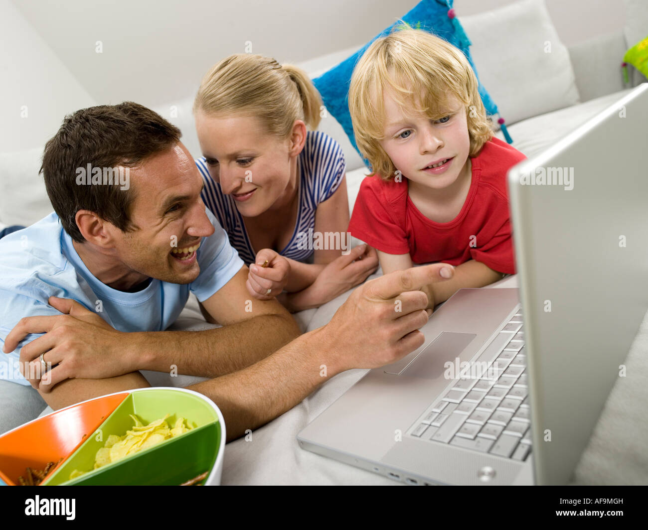 Family using laptop Stock Photo - Alamy