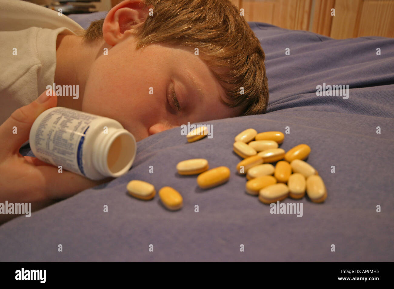 A Stock Photograph of a Yound Boy Depressed and Drugs Pouring out of a ...