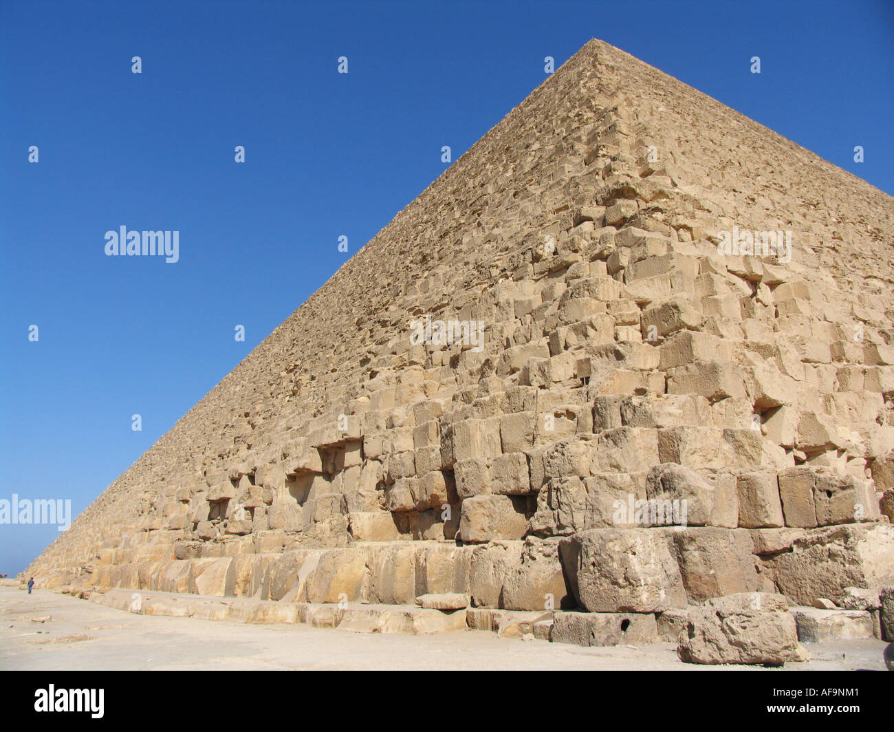 Close-up shot of one of the big pyramids of Giza with person on the ...