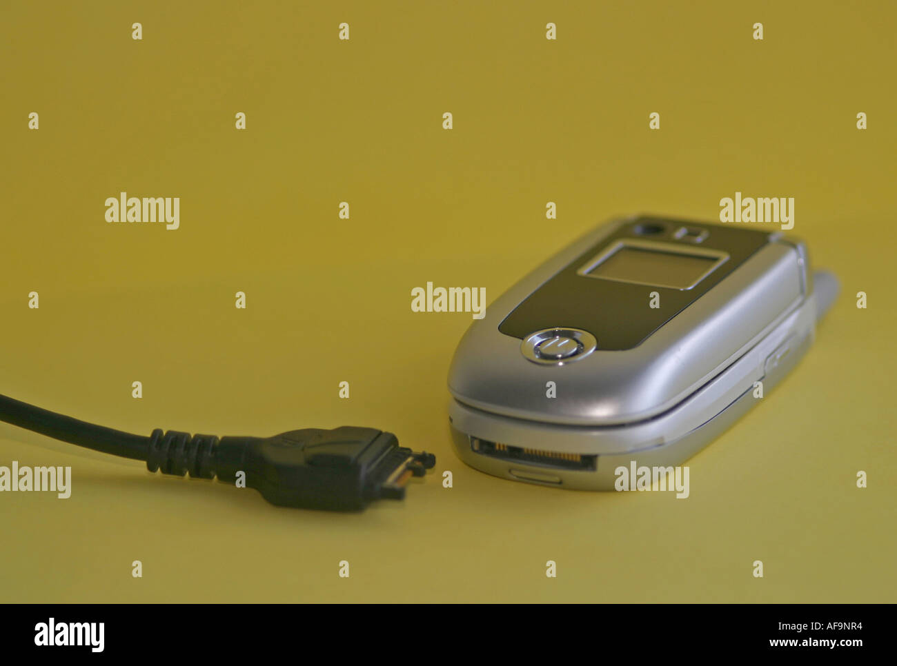 A Stock Photograph of a Mobile Phone and Wire Connecting to a Computer ...