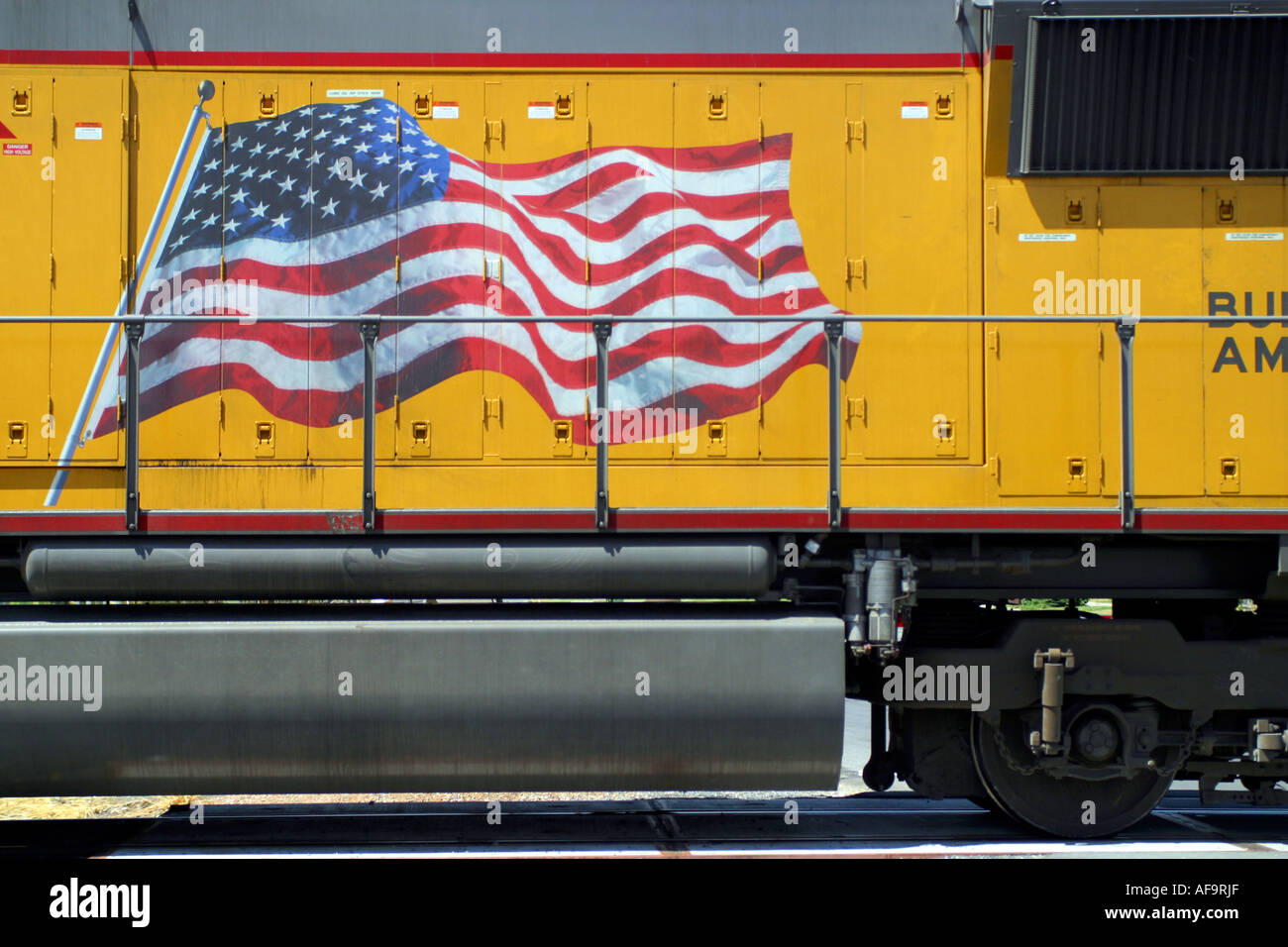 Side of yellow train locomotive engine with painted United States flag ...