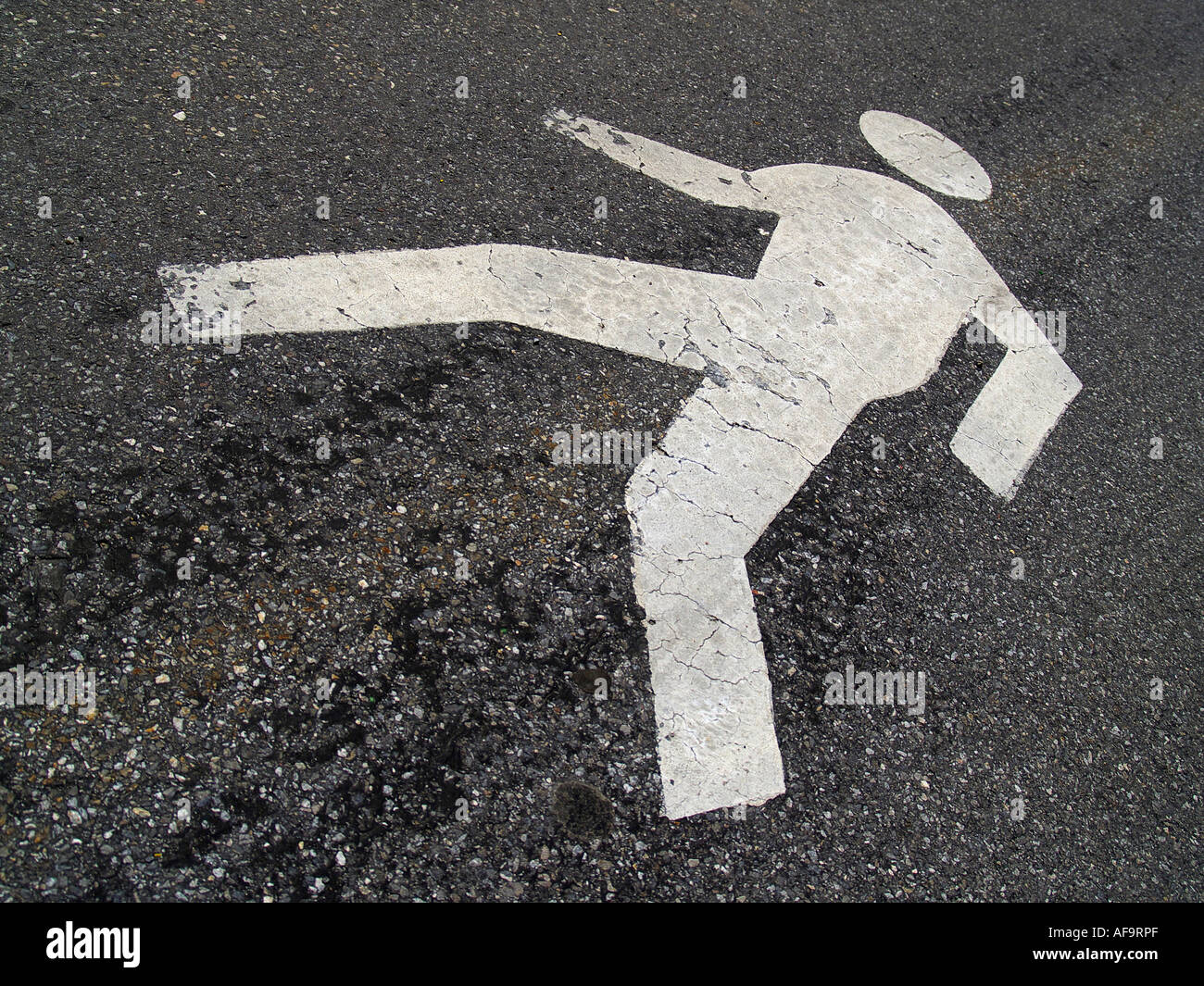 Symbol of walking pedestrian in white paint on black pavement Stock ...