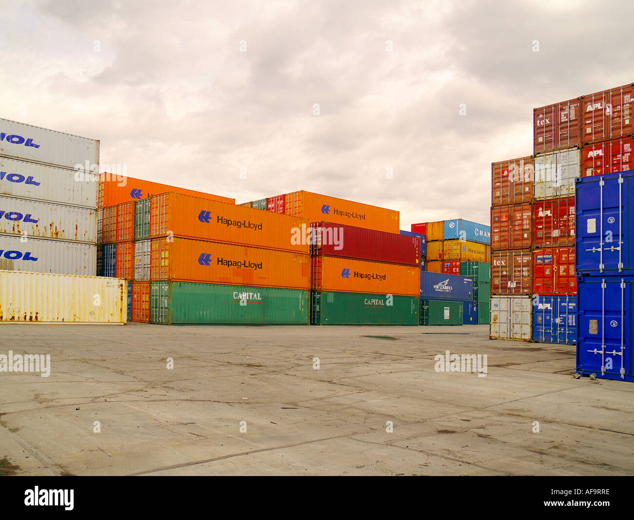 Colorful overseas shipping containers stacked in a shipping and ...