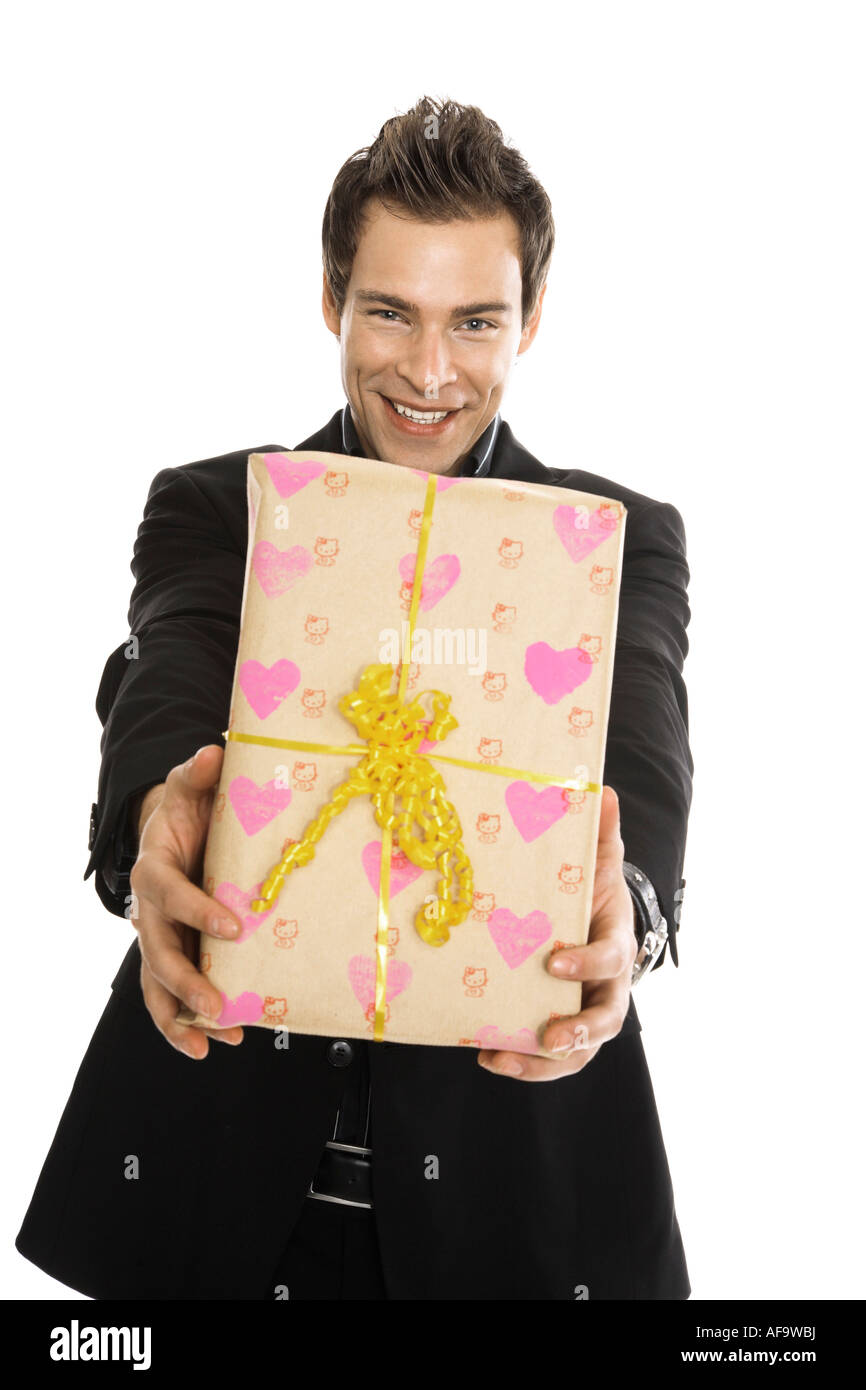 Young man holding present, close-up Stock Photo - Alamy