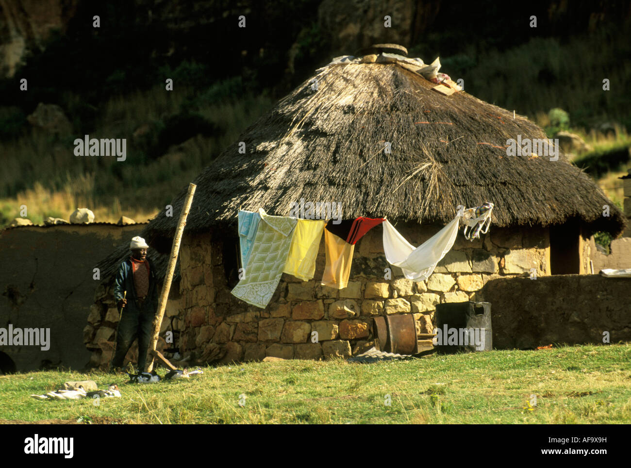 Traditional stone and thatch homestead with makeshift washing line ...