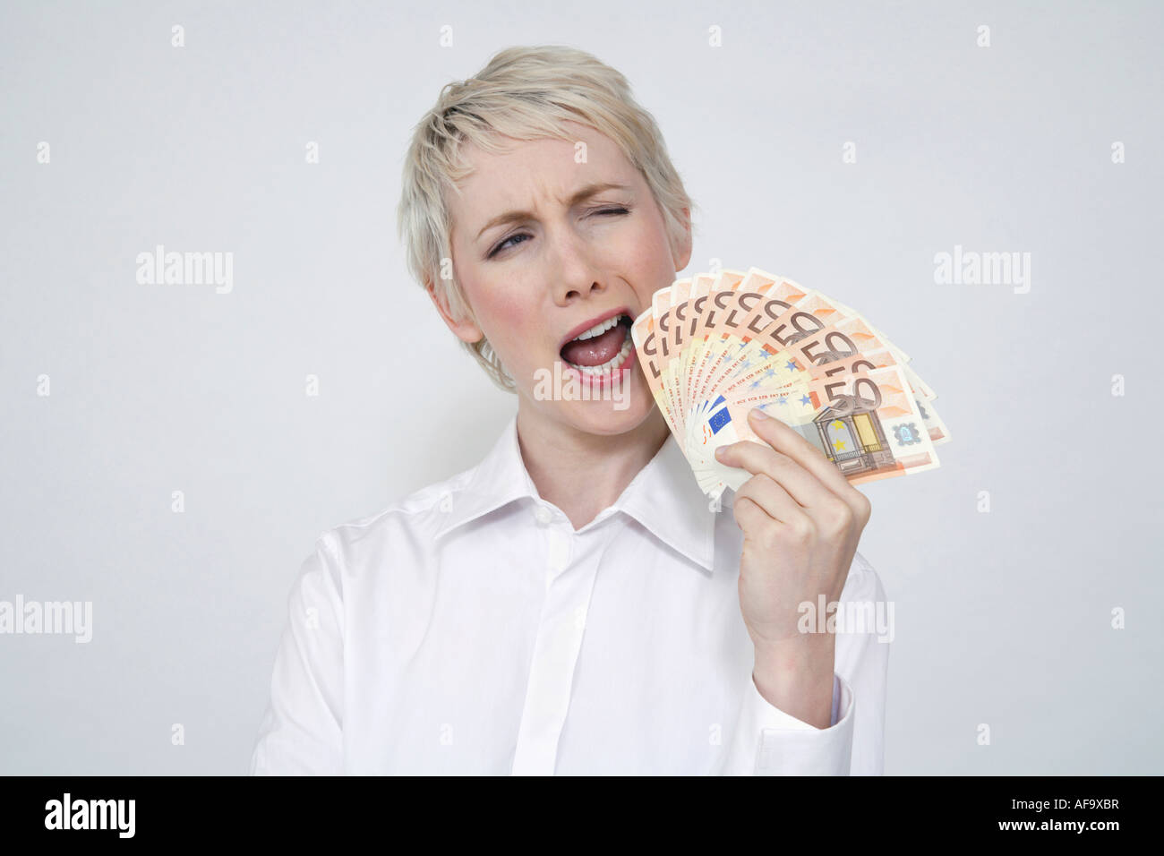 Young woman holding money, portrait Stock Photo - Alamy