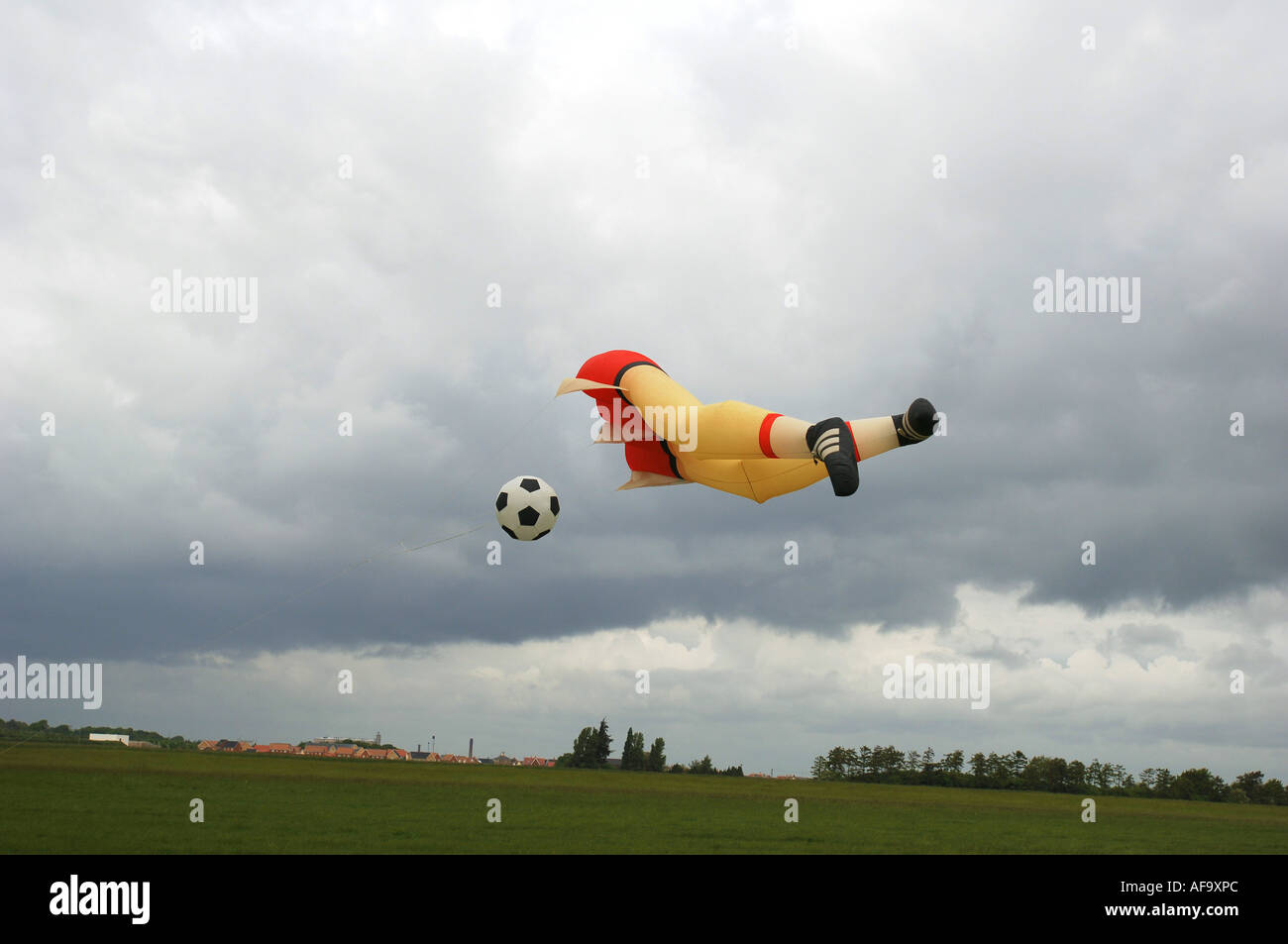 kite made in the shape of legs ands shorts with a football Stock Photo ...