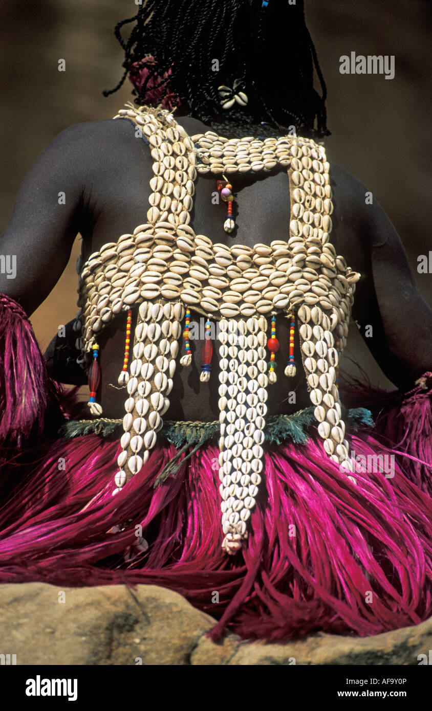 Rear view of Dogon dancer wearing elaborate beaded cowry shell ...