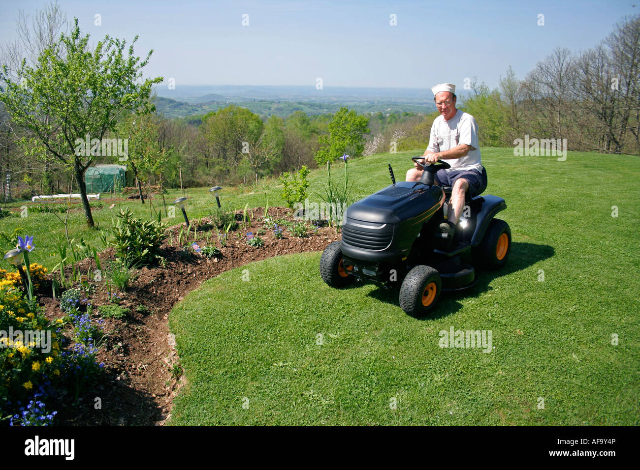Man sitting on lawn mower hi-res stock photography and images - Alamy