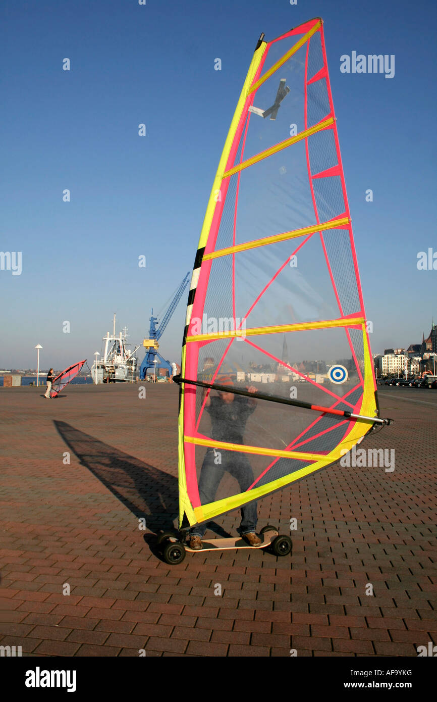 man windskating on street by seafront Stock Photo - Alamy