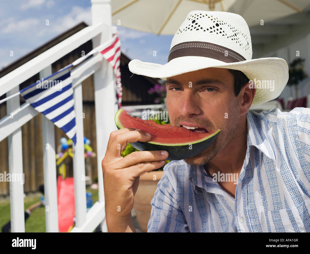 Man eating watermelon, close-up Stock Photo - Alamy