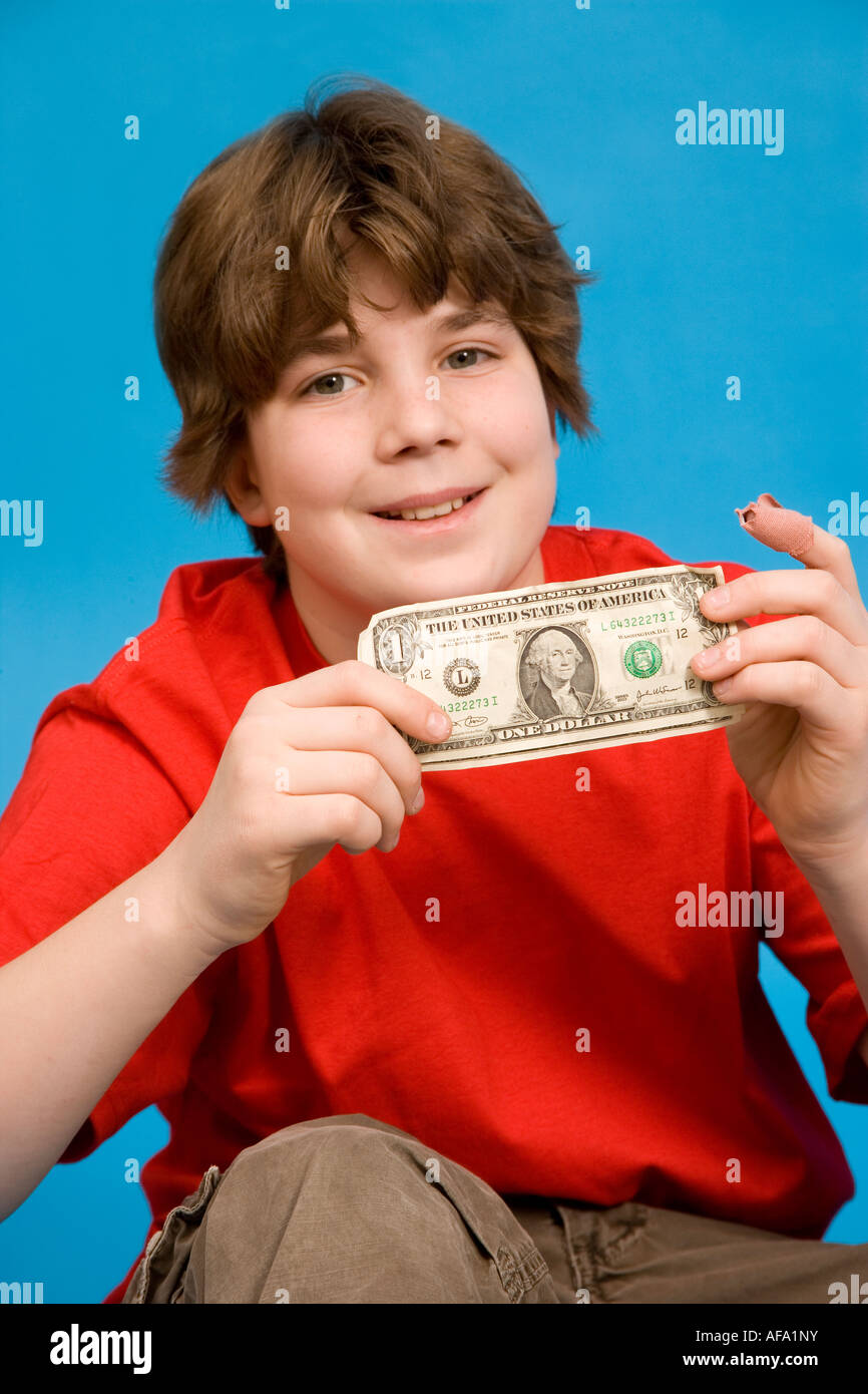 Adolescent showing off money he has earned Stock Photo - Alamy