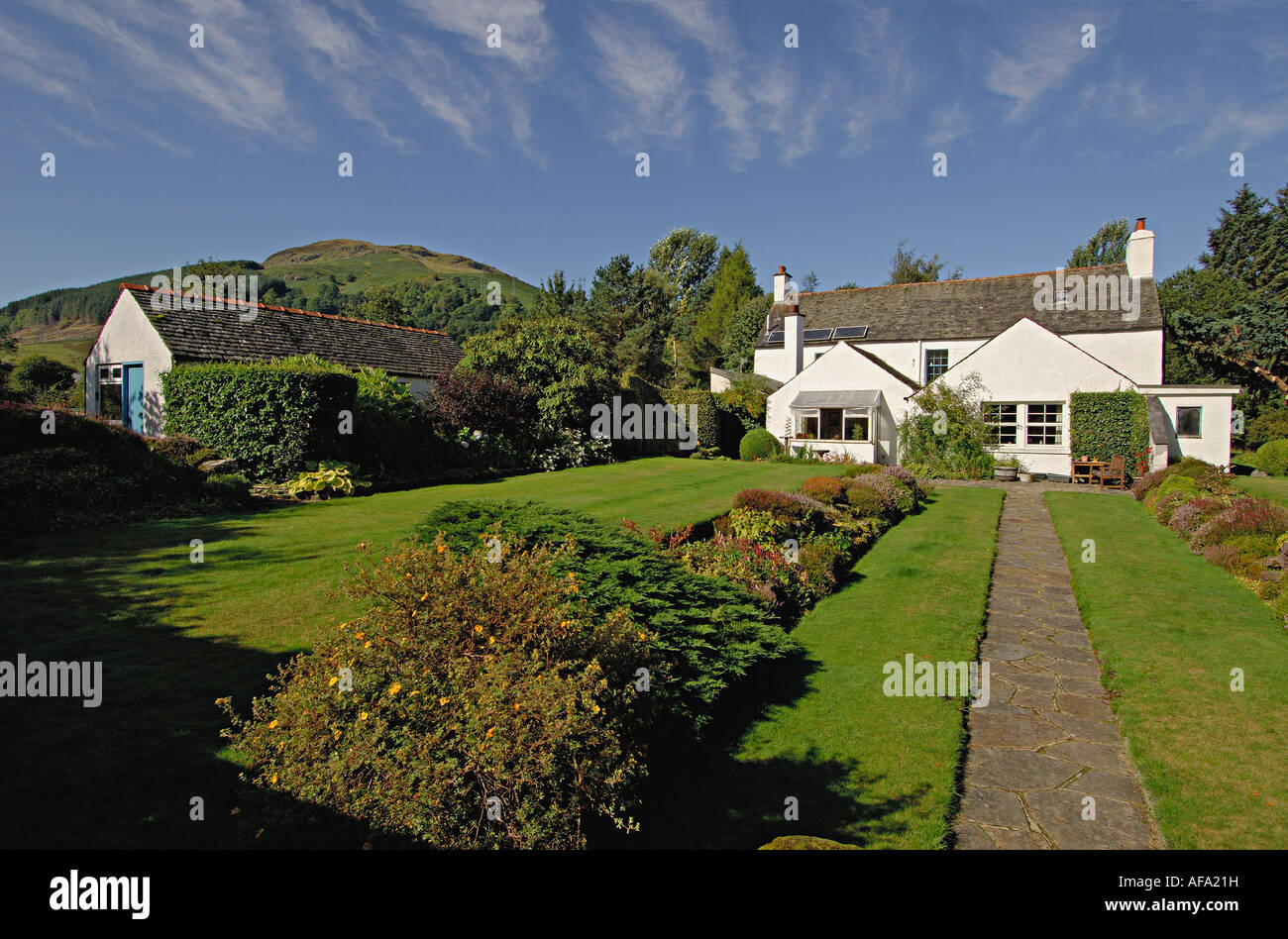 Scottish country house in high summer with outbuilding and formal ...