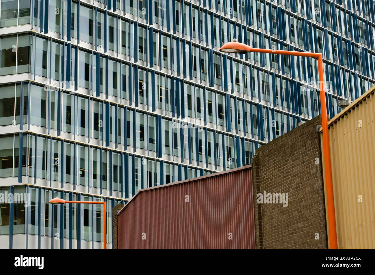 Geometric shapes of lamp-posts against modern blue windows Stock Photo ...