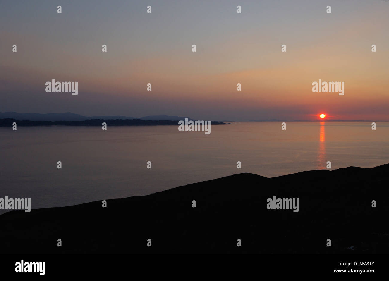 Warm summer sunset across the calm waters of the Inner Sound with the ...