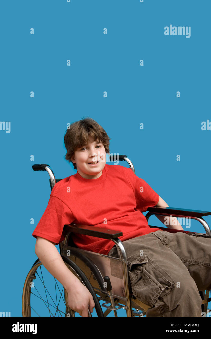 Adolescent uses or plays with wheelchair Stock Photo - Alamy