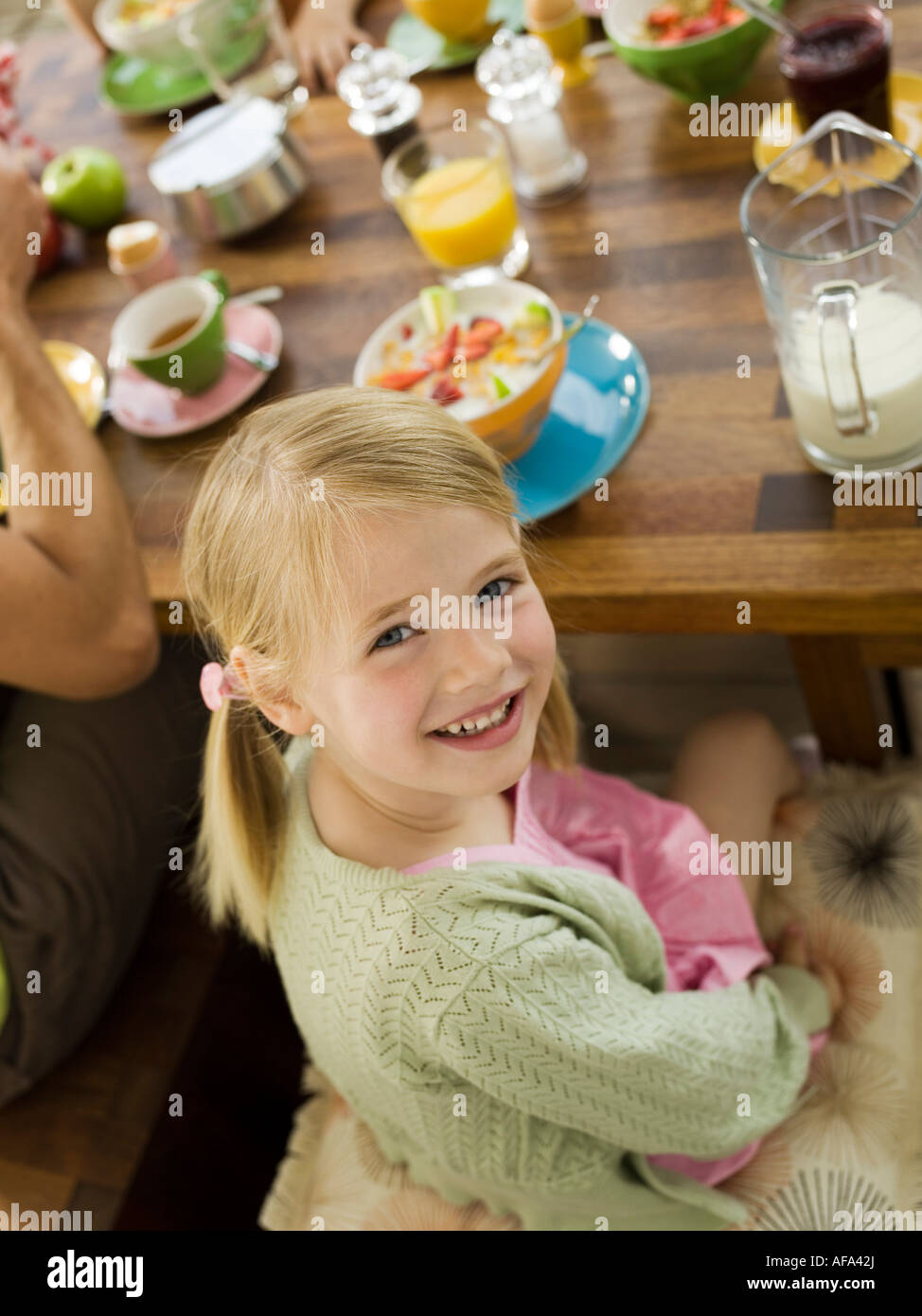 Girl at breakfast table Stock Photo - Alamy