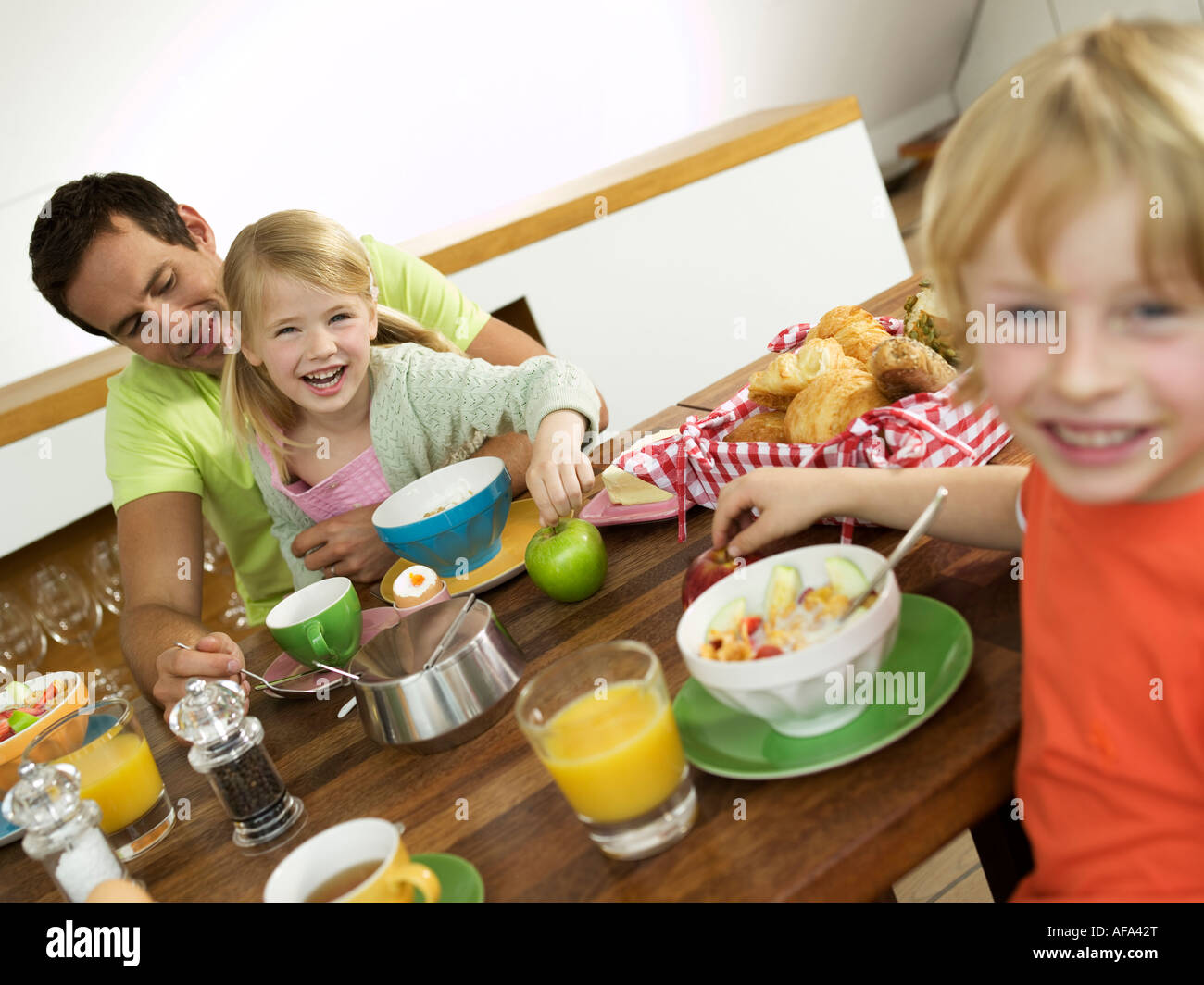 Father and children at breakfast table Stock Photo - Alamy