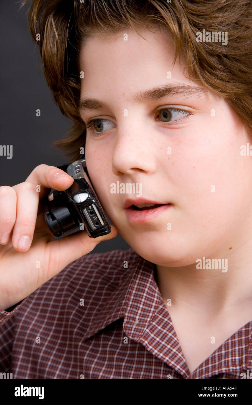 Young boy talking on his cell phone Stock Photo - Alamy