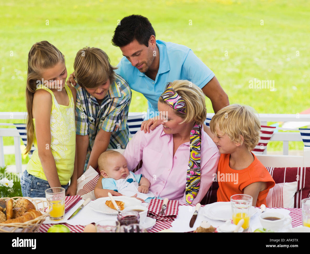 Family in garden with baby Stock Photo - Alamy