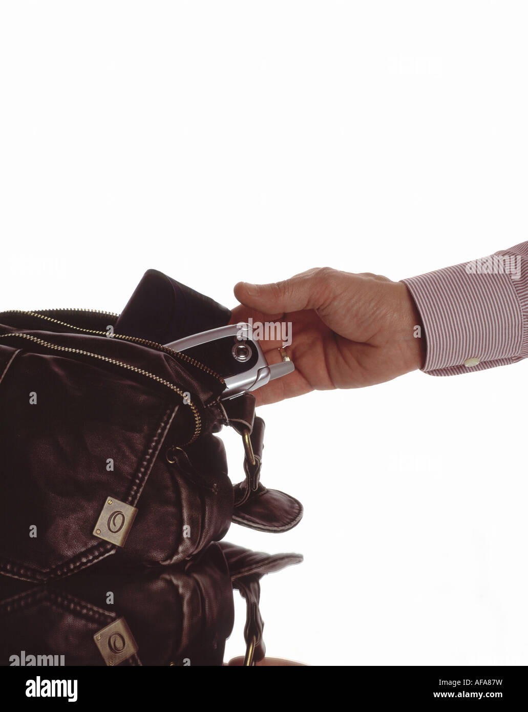 Hand reaching towards, into a handbag Stock Photo - Alamy