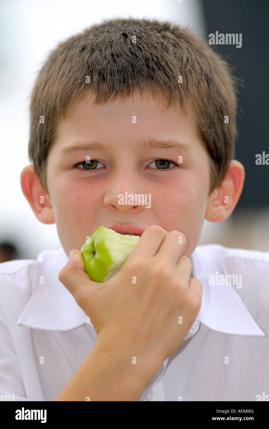 Young Boy Eating Apple Stock Photo - Alamy