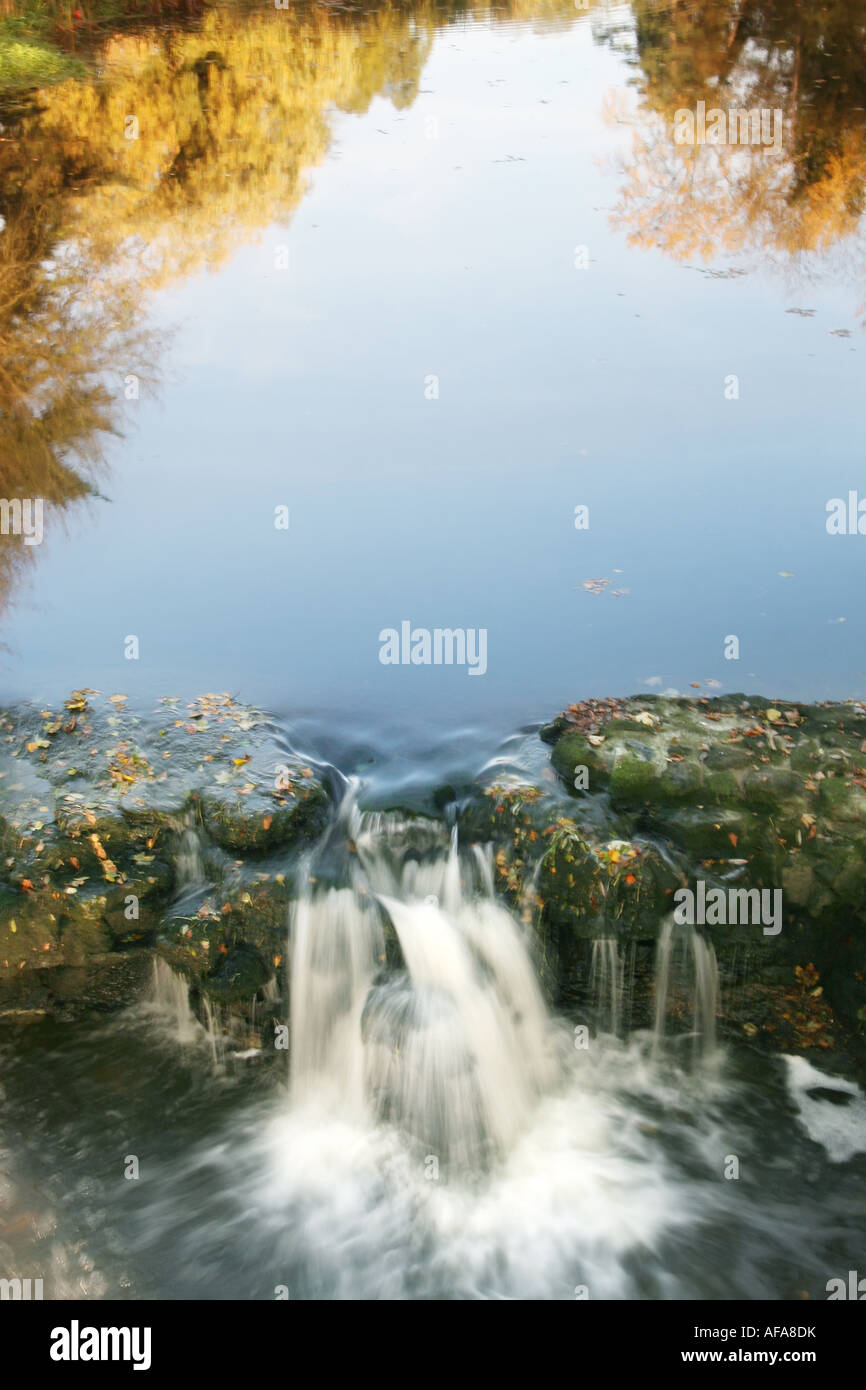 a small waterfall running off a river Stock Photo - Alamy