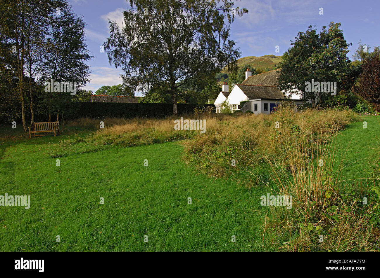 Scottish country house in high summer with surroundings of grass and ...